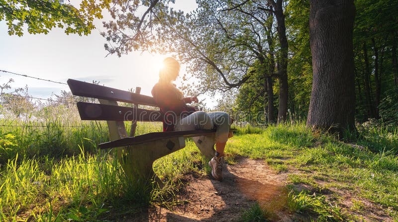 A Lonely Woman Sits on a Bench by the Forest at Spring. Benche for ...