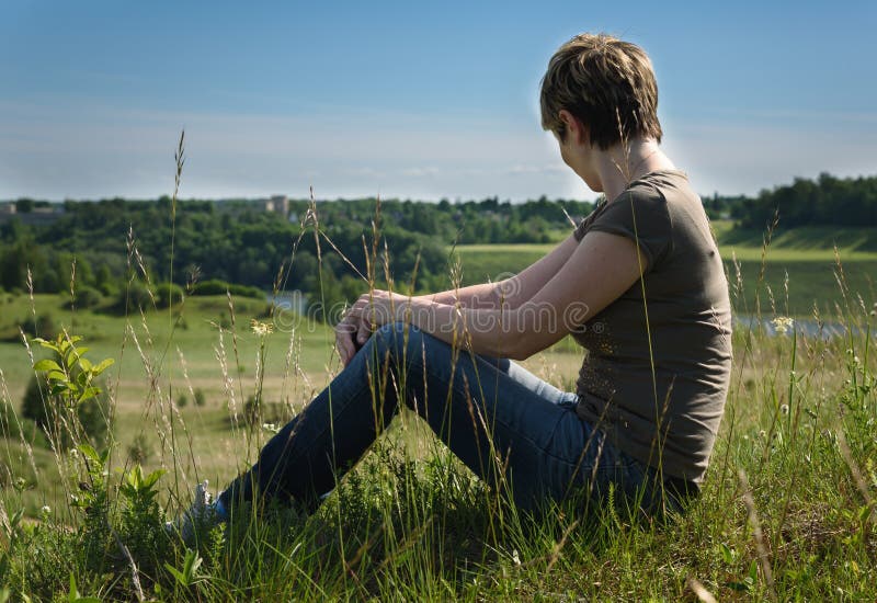 Lonely Woman Sitting with Her Back on Green Field Stock Image - Image ...