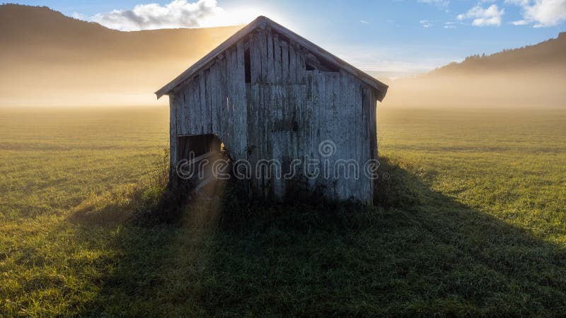 Lonely Wooden Hut in a Sunny Field Stock Photo - Image of mountains ...