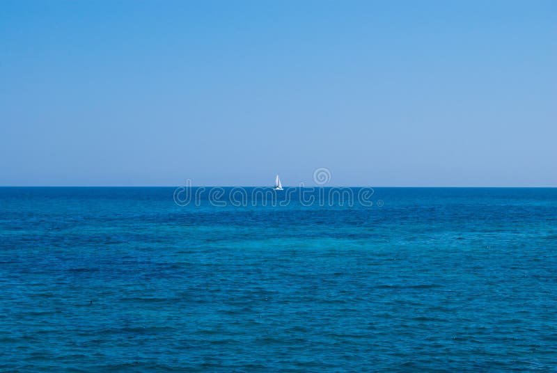 Lonely Yacht in an Open Sea Under Solid Blue Sky Stock Photo - Image of ...