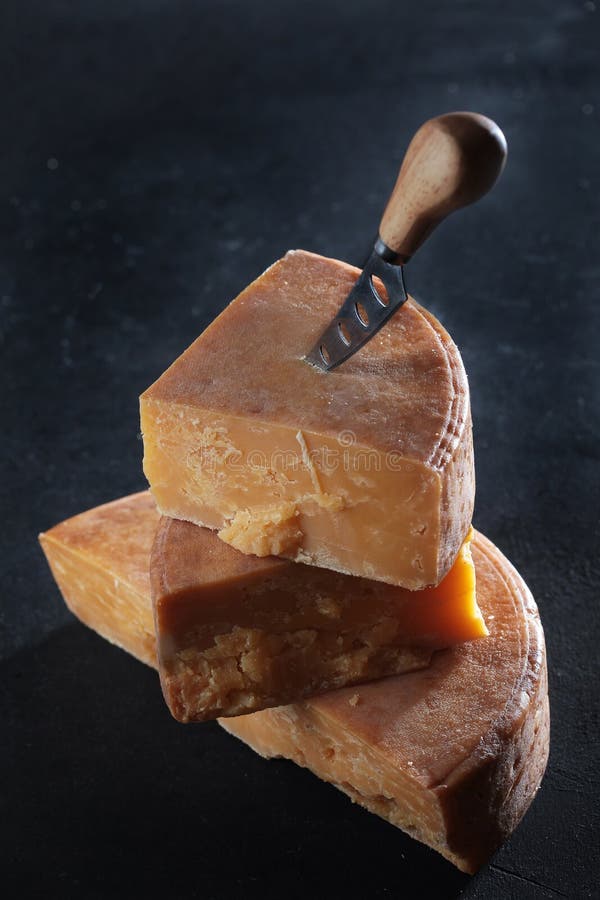 Long-aged Cheese Chunks. Hard Cheese with a Knife on a Dark Background ...