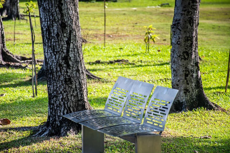 Long bench in the park stock photo. Image of greenery - 304475390