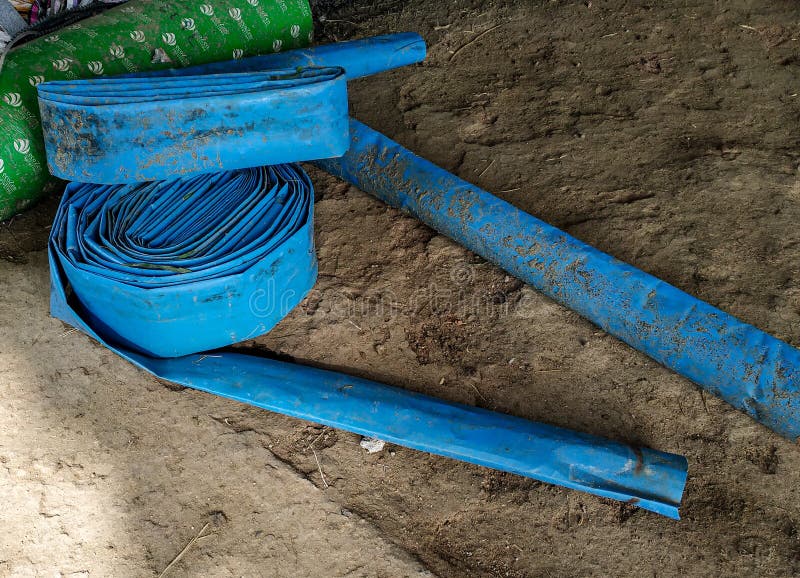 A Long Blue Pipe for Water Passing in the Field. Stock Image - Image of ...