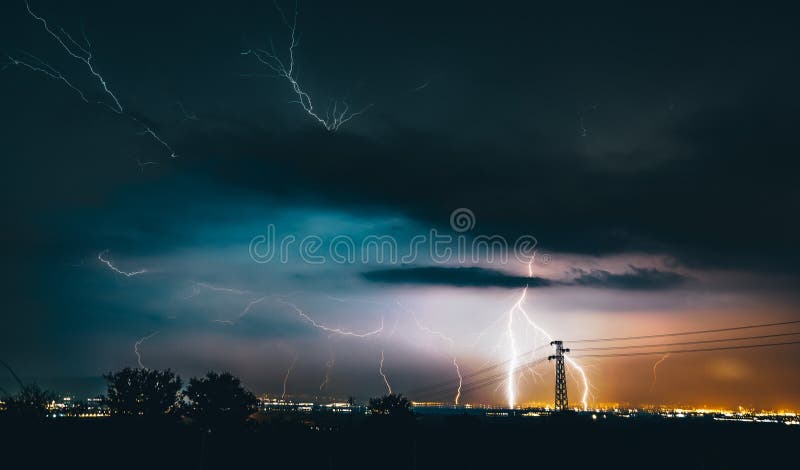 Long, Branched, Powerful Lightning Bolts Strike Down Behind the Trees ...