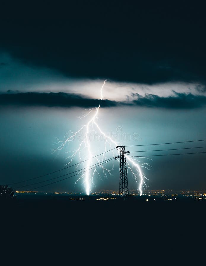 Long, Branched, Powerful Lightning Bolts Strike Down Behind the Trees ...