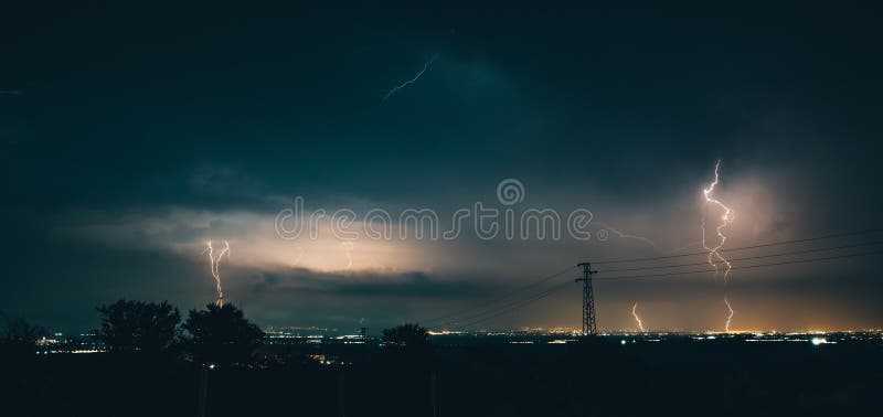 Long, Branched, Powerful Lightning Bolts Strike Down Behind the Trees ...