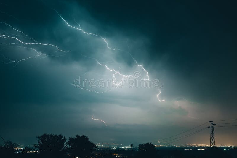 Long, Branched, Powerful Lightning Bolts Strike Down Behind the Trees ...