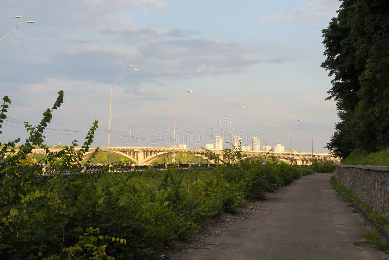 A Long Bridge Nestled between Hills Covered in Green Trees. the Bridge ...