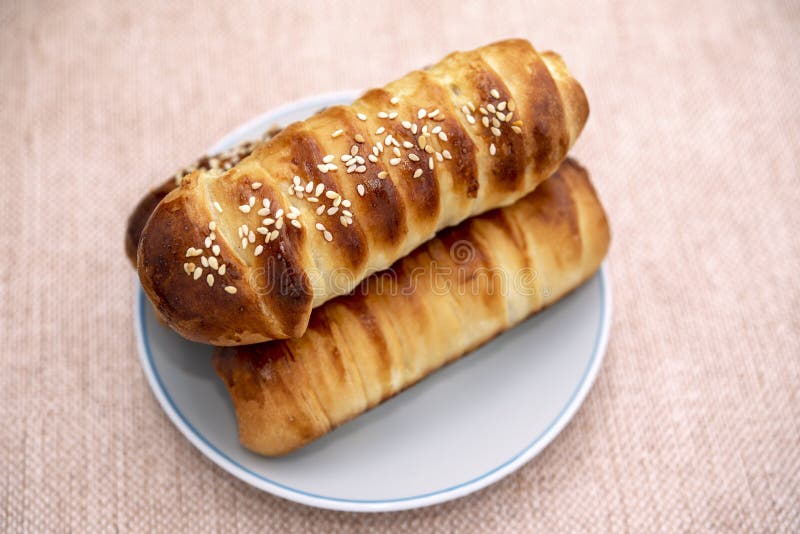 Long Bun with Sesame Seeds on a Plate Stock Photo - Image of cooking ...