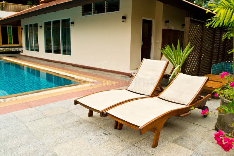 Long chairs by the pool stock photo. Image of invite - 39382304