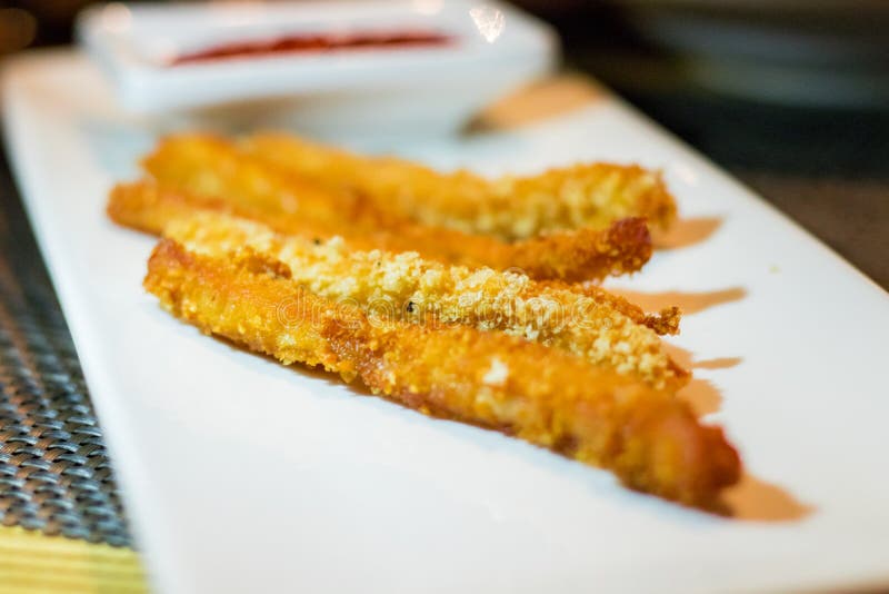Long Chicken Nuggets Strips with Ketchup on a White Rectangular Plate ...