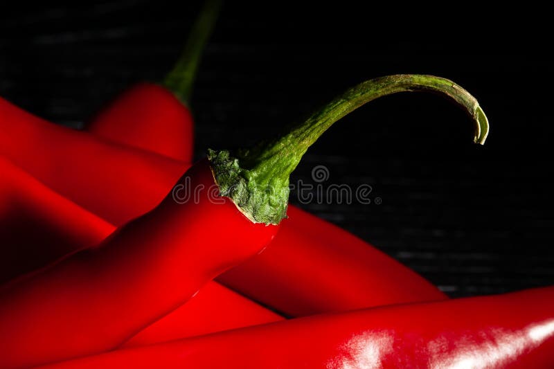 Long chili pepper on black stock photo. Image of fresh - 324954986