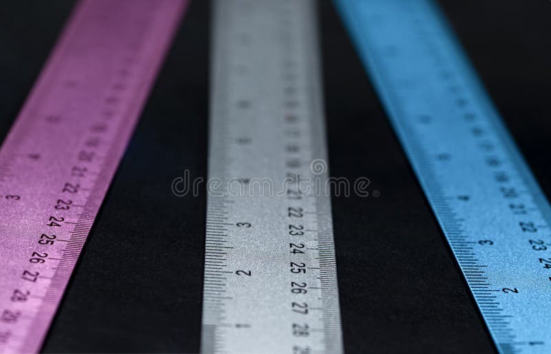 Long Colorful Metal Rulers on Black Tabletop Stock Image - Image of ...
