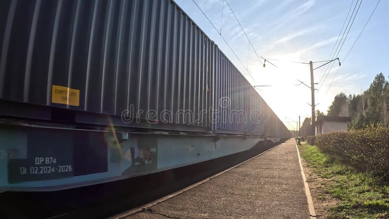 A Long Container Train is Smoothly Moving Along the Track Under a ...