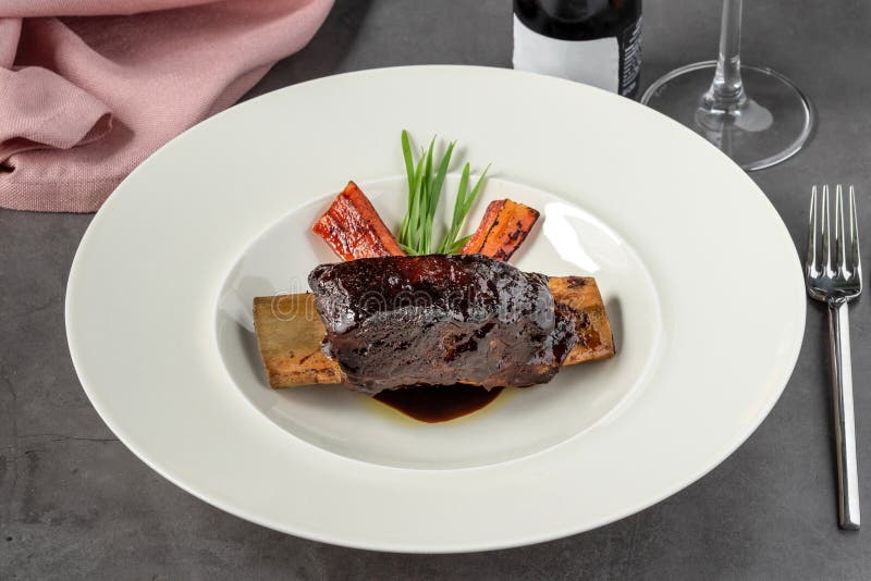 Long Cooked Marinated Beef Ribs on a White Porcelain Plate Stock Image ...