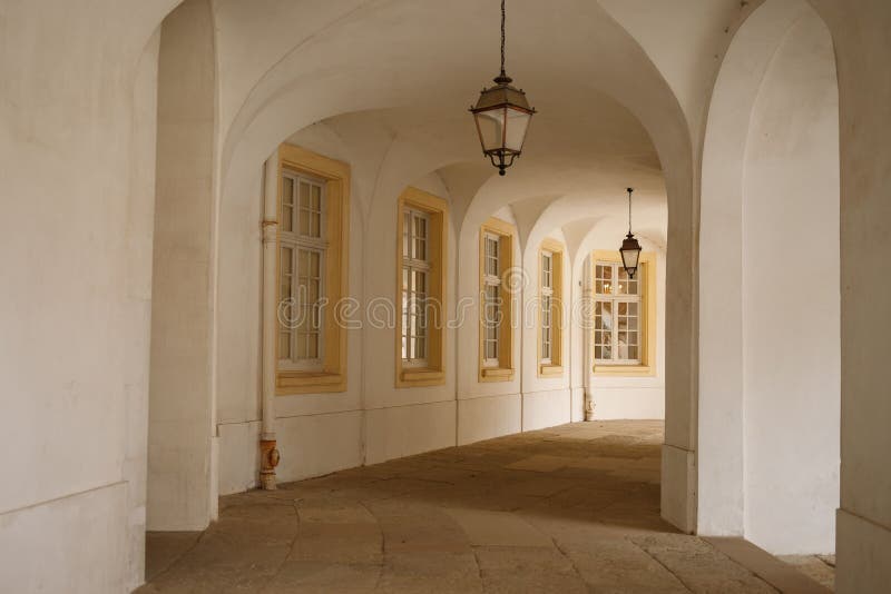 Long Corridor with Arched Vaults and White Walls, Featuring Windows ...
