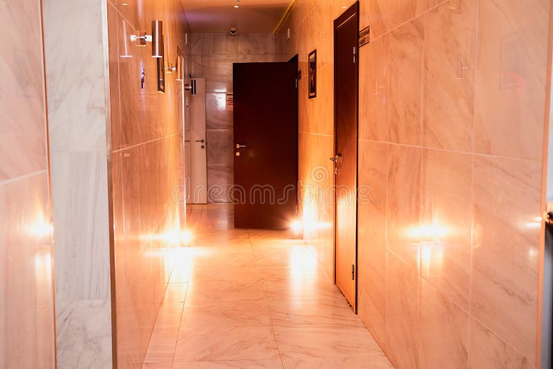 Long Corridor with Doors and Orange Light Stock Photo - Image of carpet ...