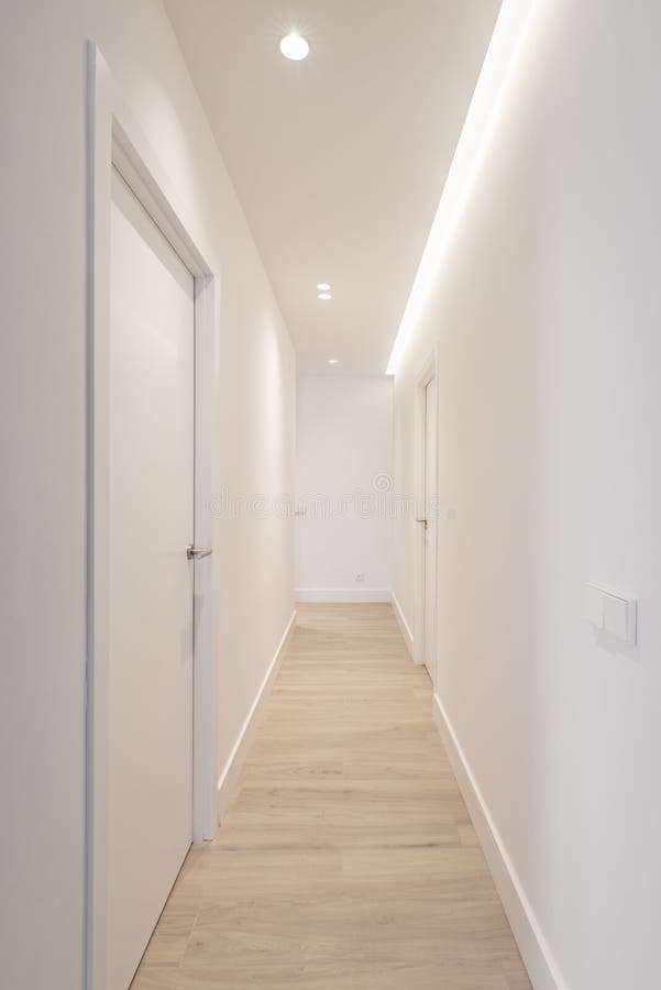 A Long Corridor in a House with Smooth White Materials and Light Oak ...