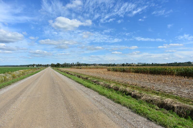 Long country road stock photo. Image of blue, farm, clouds - 65566474