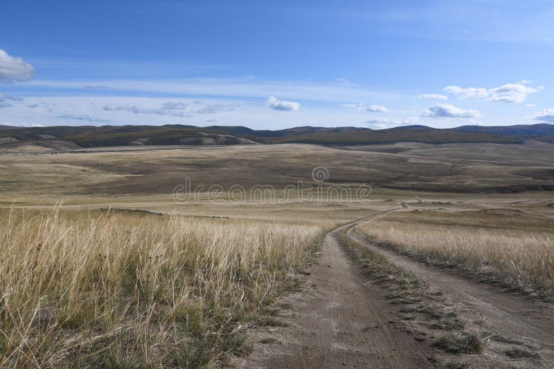 A Long and Crooked Road through the Steppe with a Blue Sky Stock Photo ...