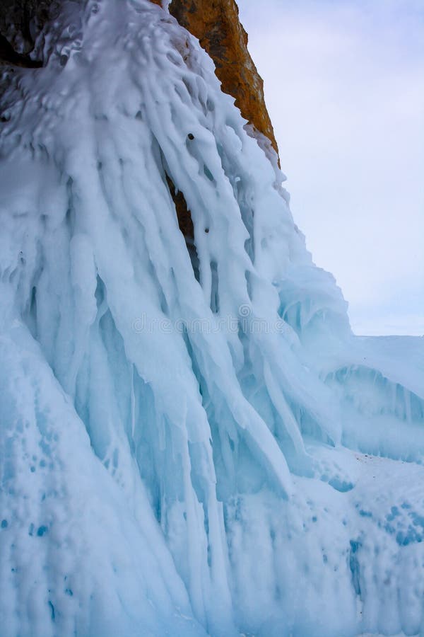 Long Curved Icicles Melted in the Sun Hang on a Rock. Stock Photo ...