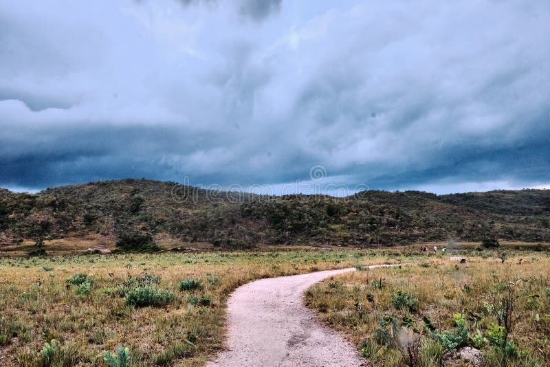 Long Curvy Pathway Leading To the Mountain Under the Cloudy Sky Stock ...