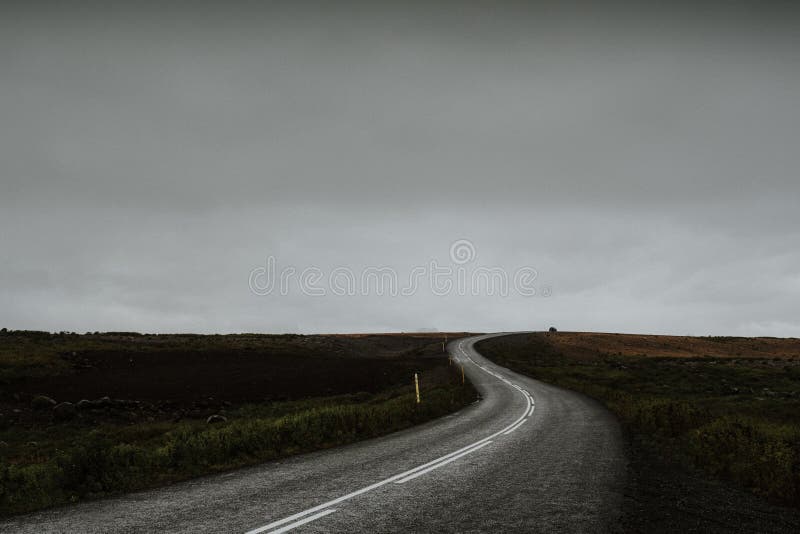 Long Curvy Road in the Middle of a Green Field in Iceland Stock Image ...