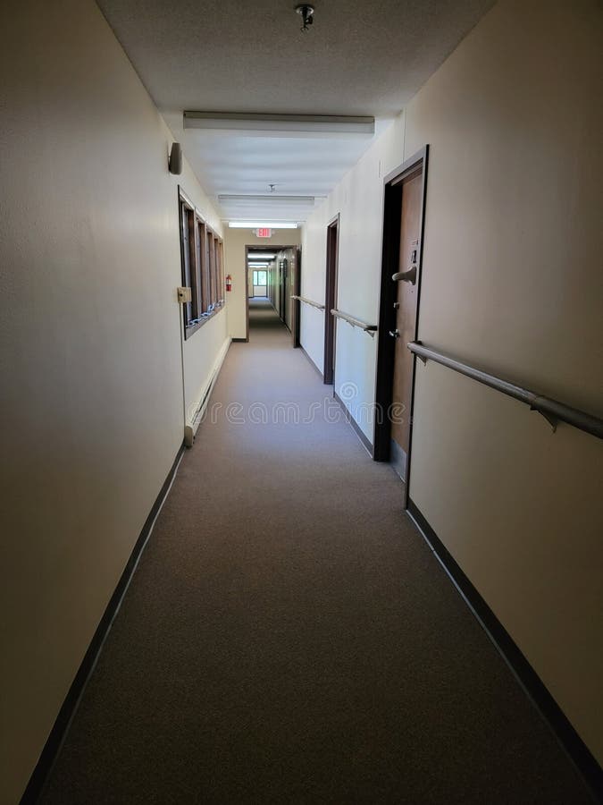 Long Dark Hallway with Exit Sign Stock Photo - Image of building ...