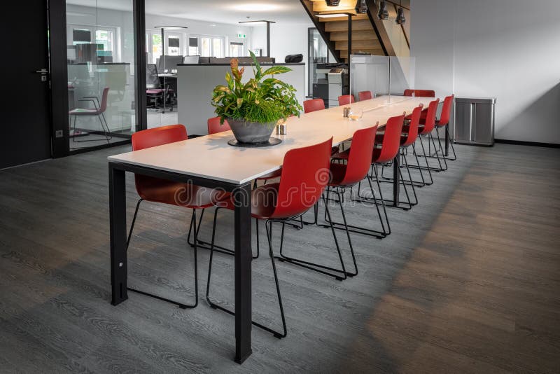 Long Dining Table with Red Chairs in an Office Building Stock Image ...