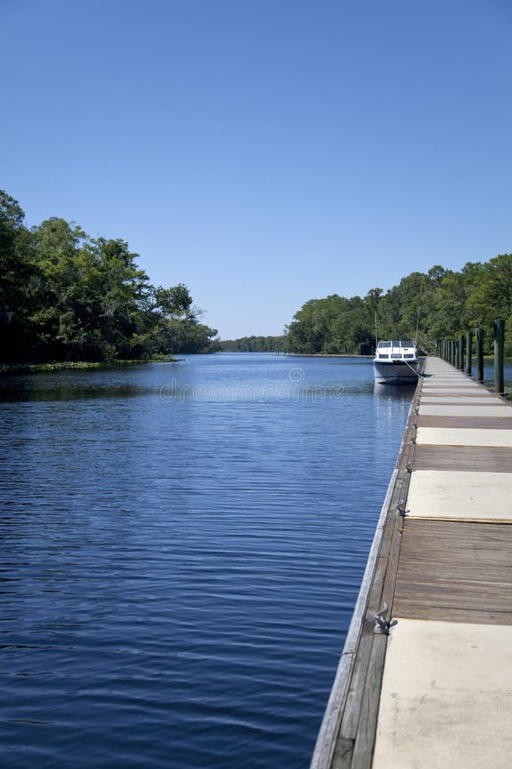 Long Dock with Boat on a River Stock Photo - Image of dock, sheltered ...