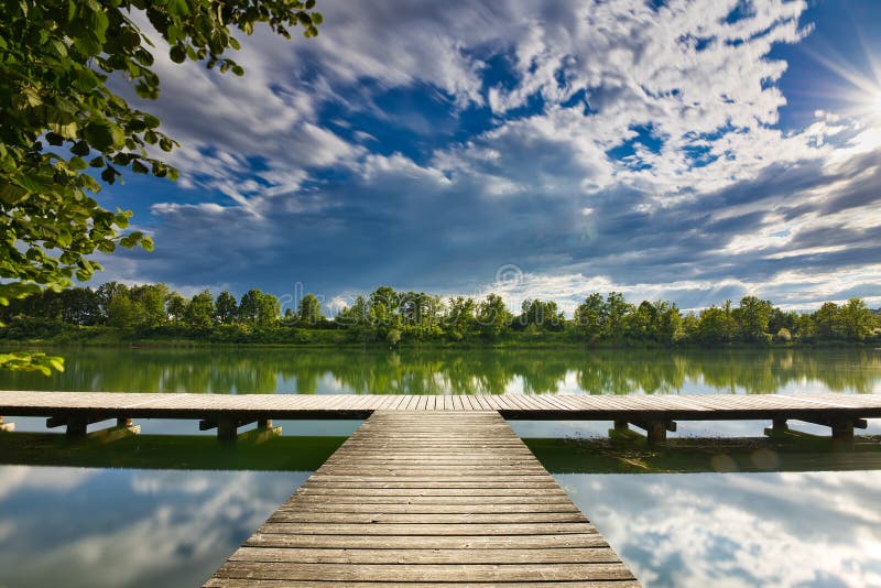 Long Dock Going Out into the Lake on a Summer Day Stock Image - Image ...