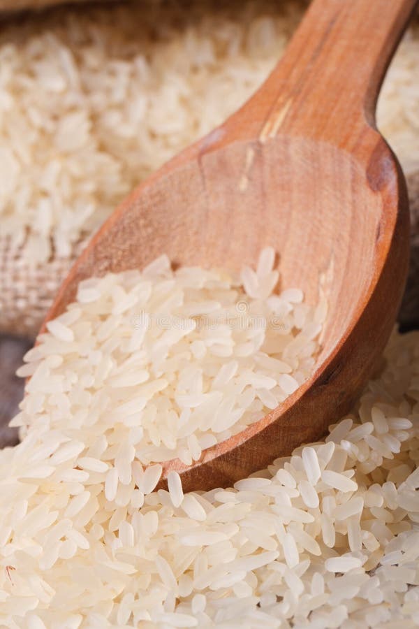 Long Dry Rice Macro Spill Out of a Wooden Spoon Stock Photo - Image of ...
