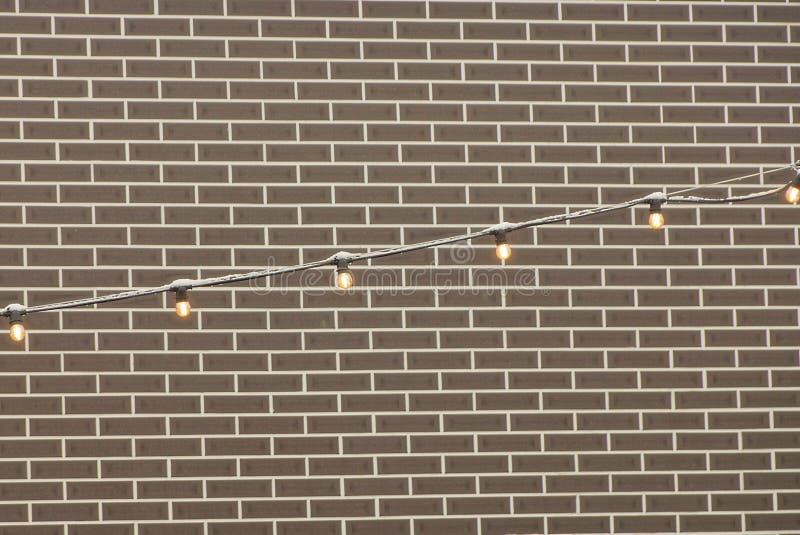 A Long Electric Cable with Light Bulbs with Yellow Lighting Stock Photo ...