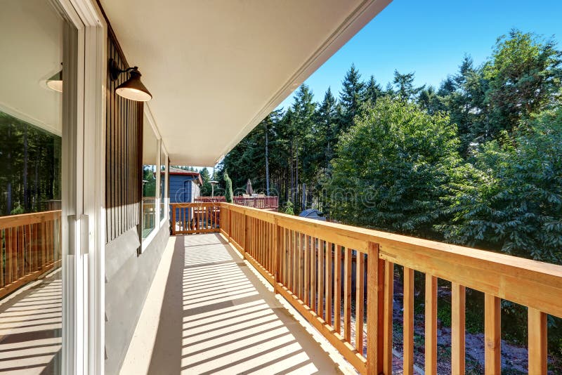 Long Empty Deck with Wooden Railings and Backyard View. Stock Image ...