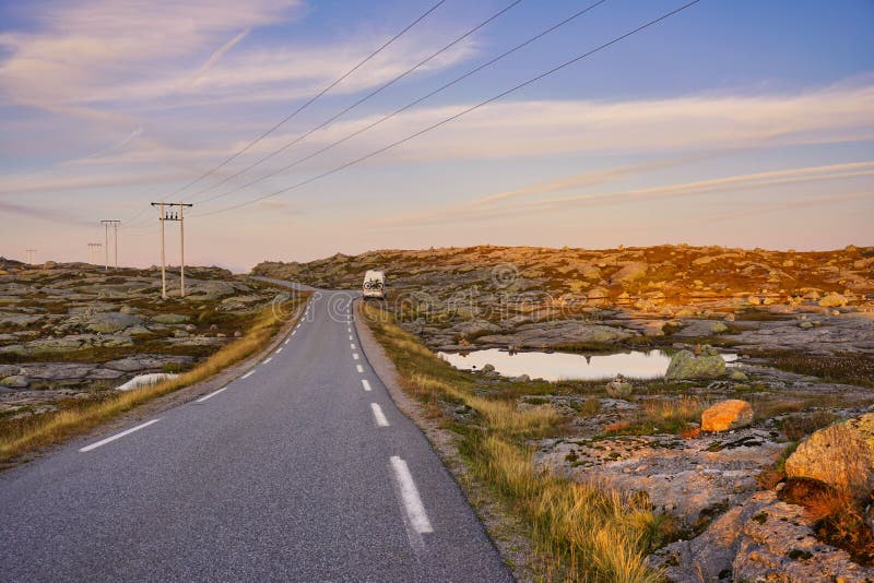 A Long Empty Road that is Going through a Mountain Range Stock Image ...
