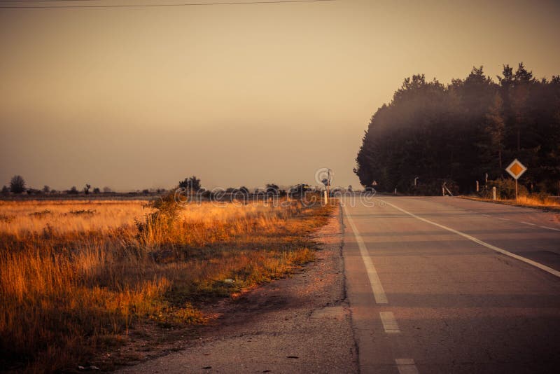 A Long Empty Road that is Going through a Mountain Range Stock Image ...