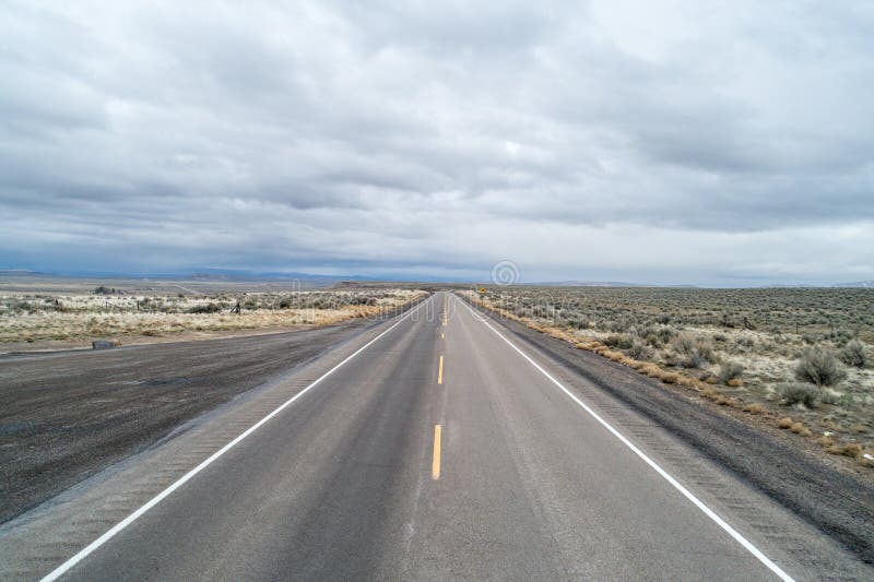 A Long, Empty Road with a Few Trees in the Distance Stock Photo - Image ...