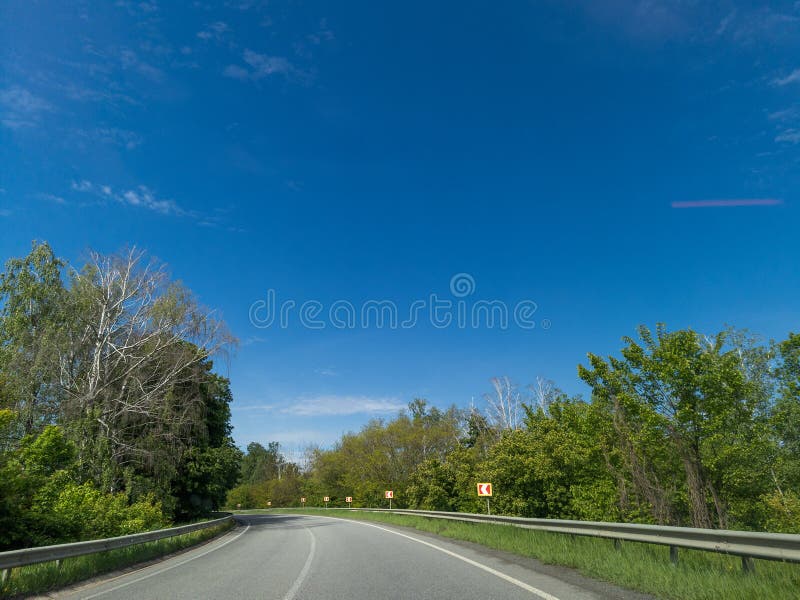 A Long Empty Road in the Middle of a Forested Area Stock Image - Image ...