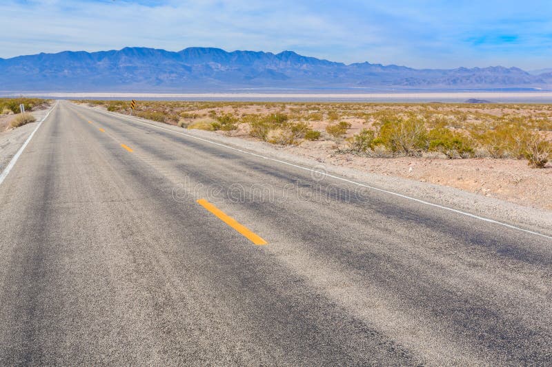 A Long, Empty Road with a Yellow Line Down the Middle Stock Photo ...