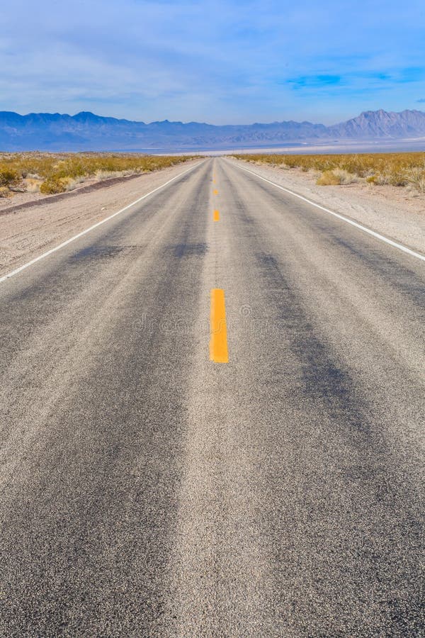 A Long, Empty Road with a Yellow Line Down the Middle Stock Photo ...