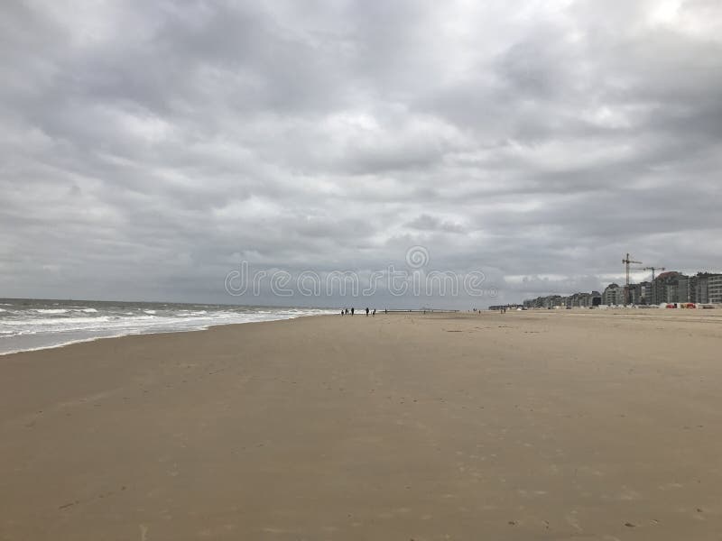 Long Empty Sandy Beach on a Cold Overcast Day Stock Photo - Image of ...