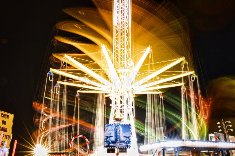 Long Exposure of a Brightly Lit Carousel at Night, Capturing Motion ...
