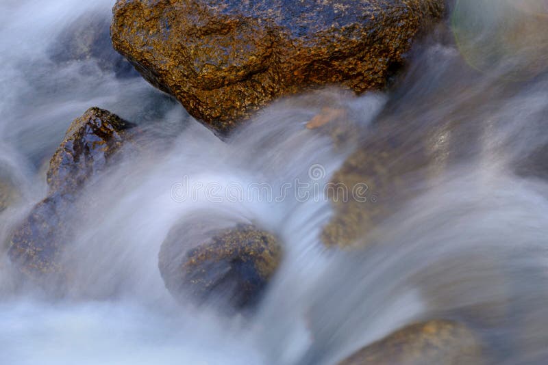 Long Exposure of a Closeup View of Water Flowing Down Stones Stock ...