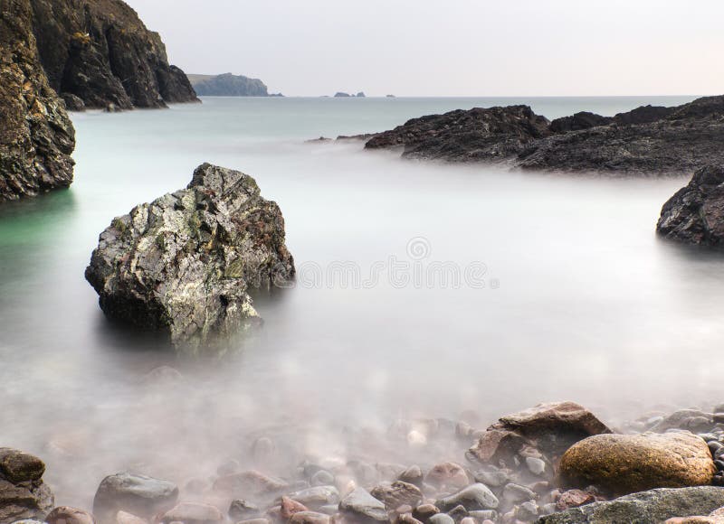 The Flowing Tide of Water through Rocks in Vertical Stock Image - Image ...