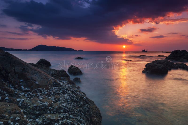 Long Exposure Image of Dramatic Sky Seascape with Rock in Sunset ...
