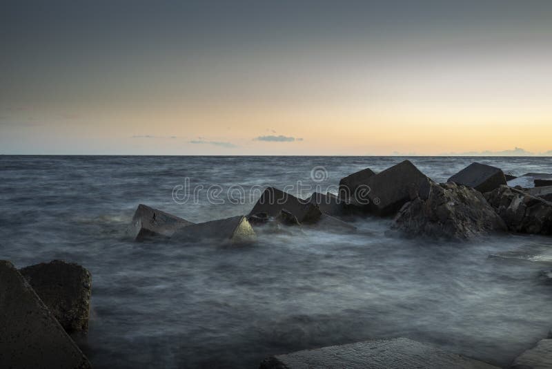 Long Exposure Image of Dramatic Sky Seascape with Rock in Sunset ...