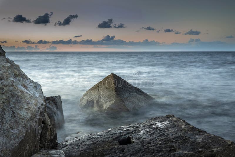 Long Exposure Image of Dramatic Sky Seascape with Rock in Sunset ...