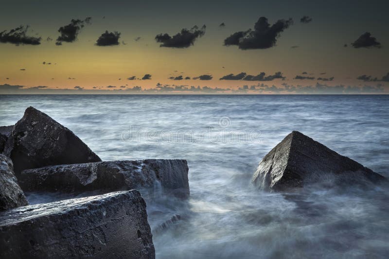 Long Exposure Image of Dramatic Sky Seascape with Rock in Sunset ...