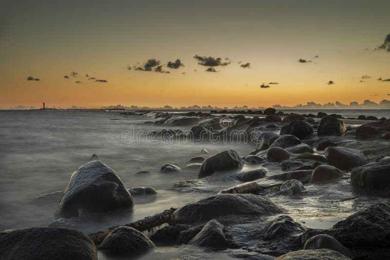 Long Exposure Image of Dramatic Sky Seascape with Rock in Sunset ...