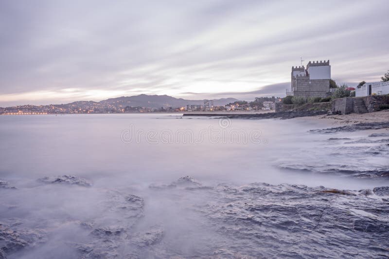 Long Exposure Image of Rocks between Sand and Mist during High Tide on ...